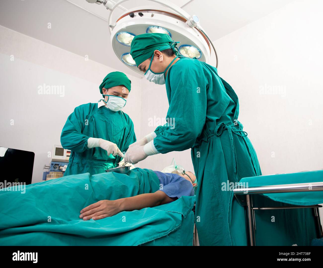 Group of team doctor and surgeon doing surgery with patient in the ...