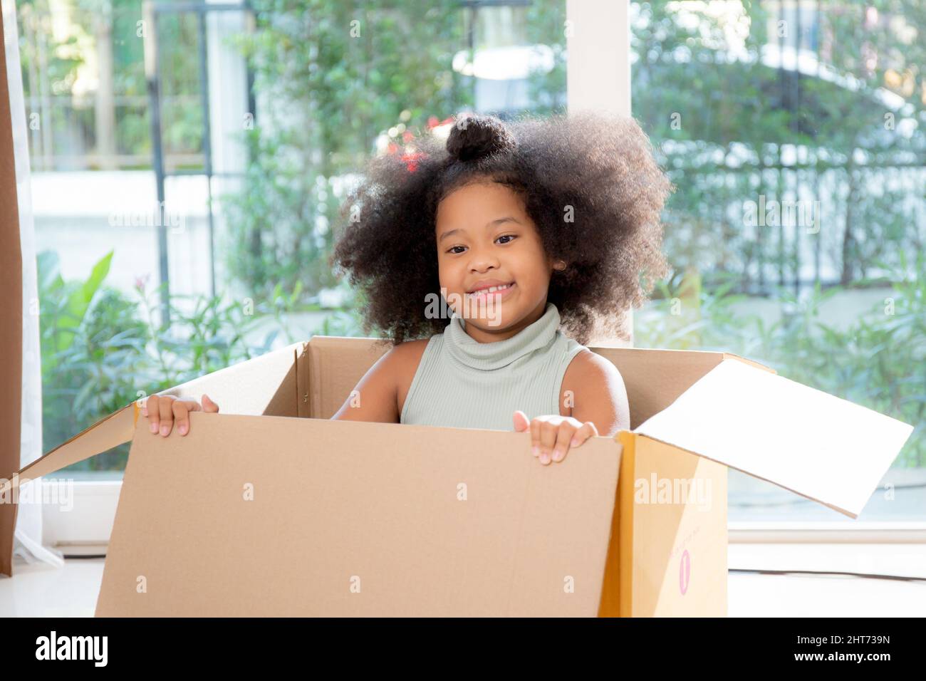 Happiness African children hiding inside box with playful and ...