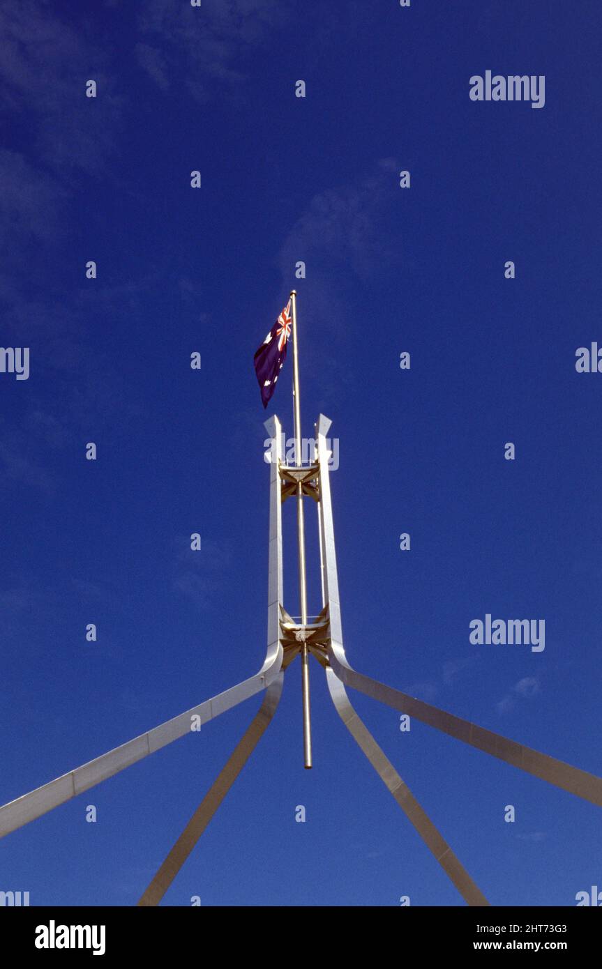 The Australian Flag rises above the parliament buildings in Canberra ...