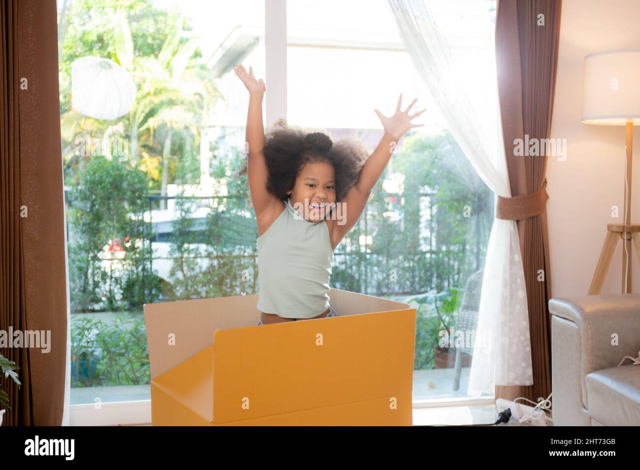 Happiness African children hiding inside box with playful and ...