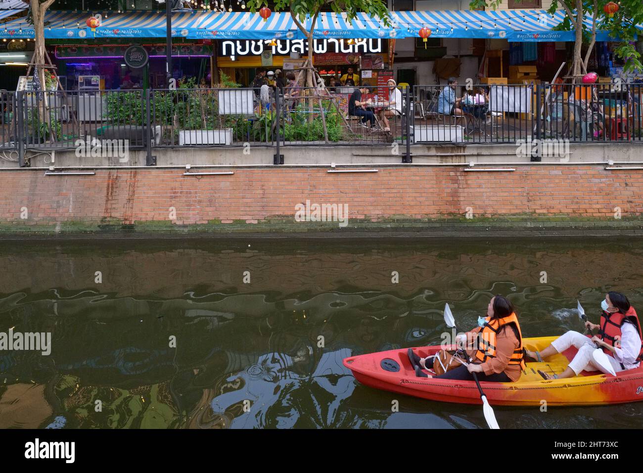 Sightseers kayaking on Klong Ong Ang in Bangkok, Thailand, a canal ...