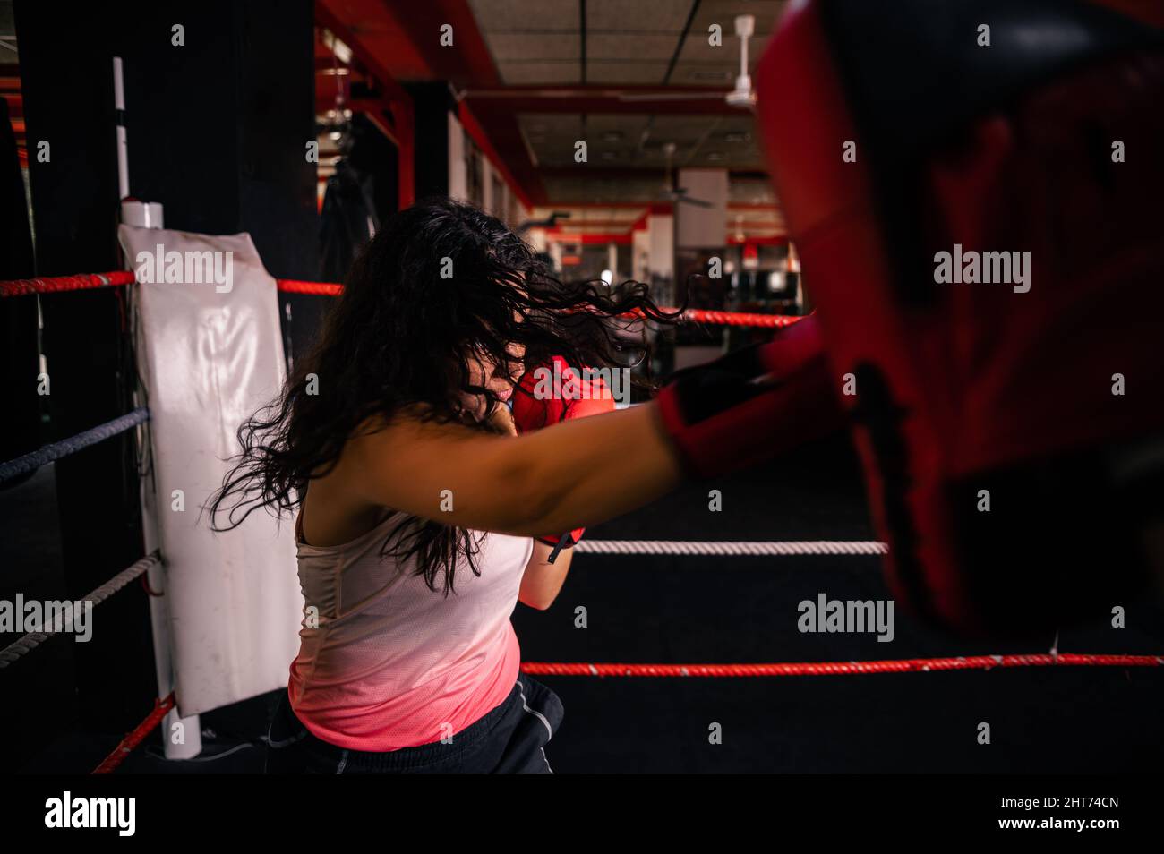 Caucasian brunette female practicing boxing in the ring Stock Photo - Alamy