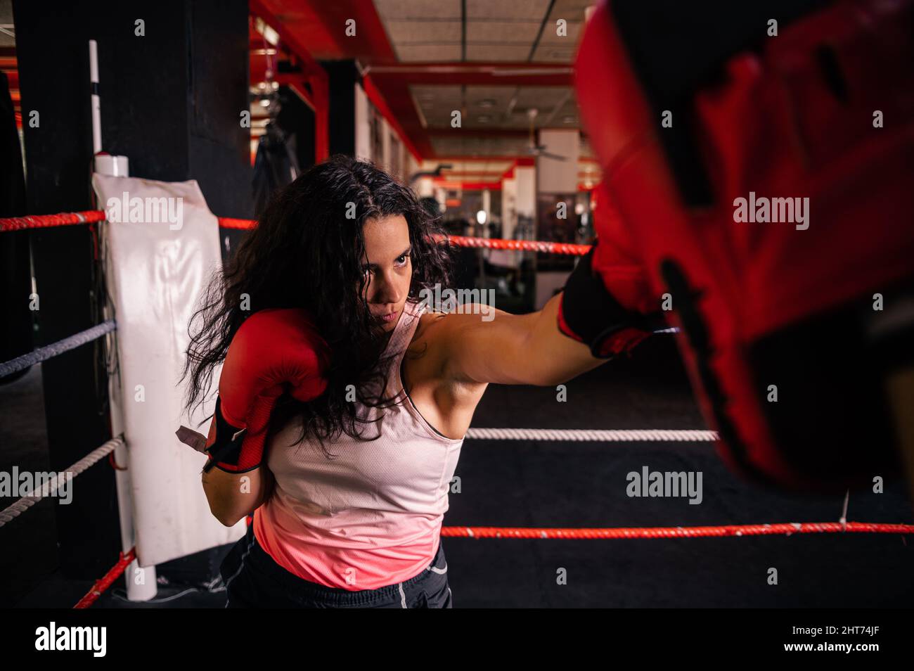Caucasian brunette female practicing boxing in the ring Stock Photo - Alamy