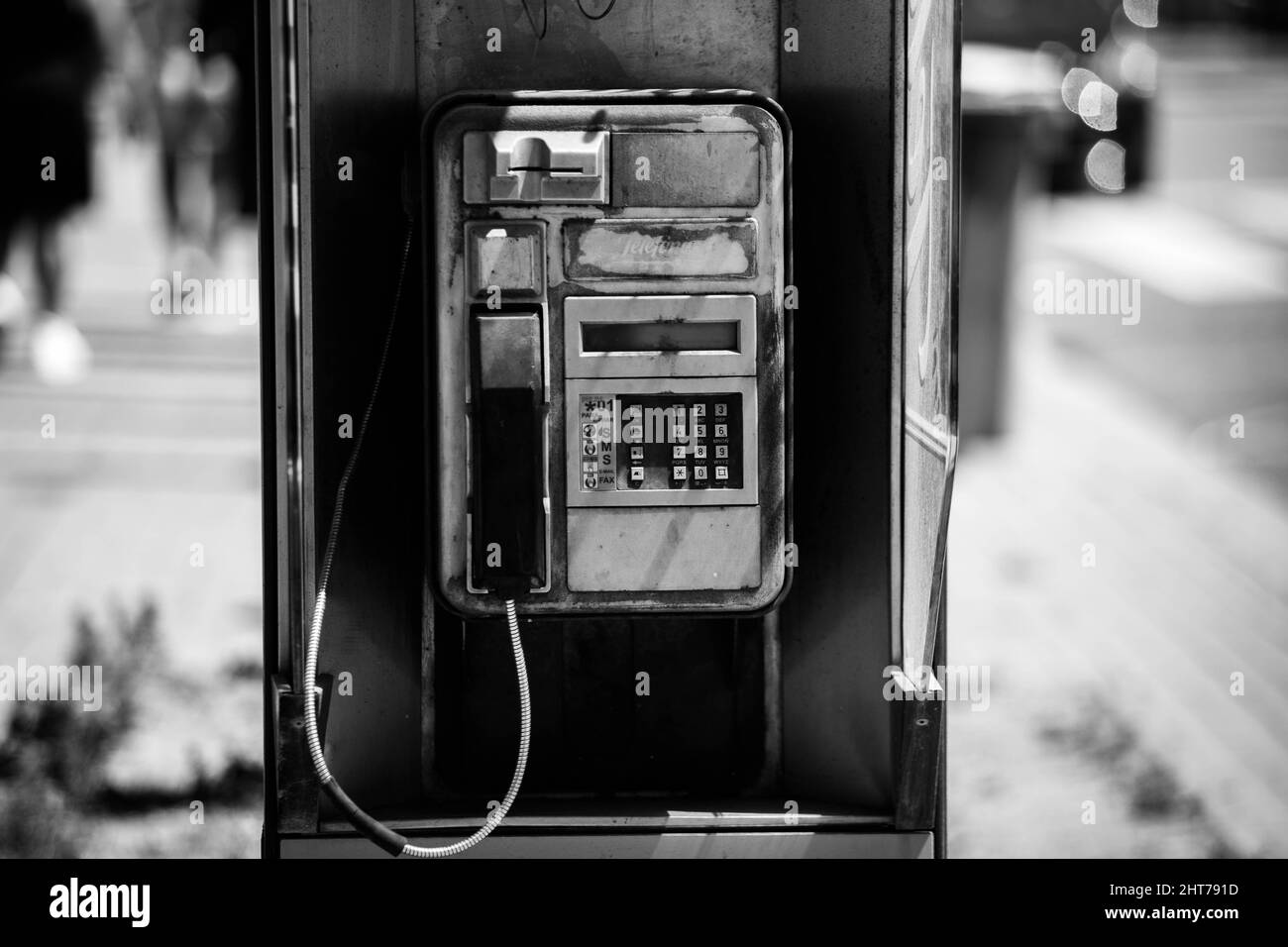 Grayscale of an old telephone outside Stock Photo - Alamy