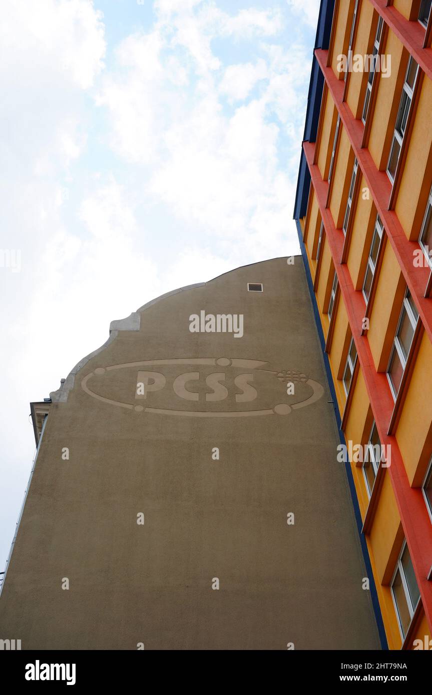 Vertical low angle shot of an office building with the PCSS logo on the ...