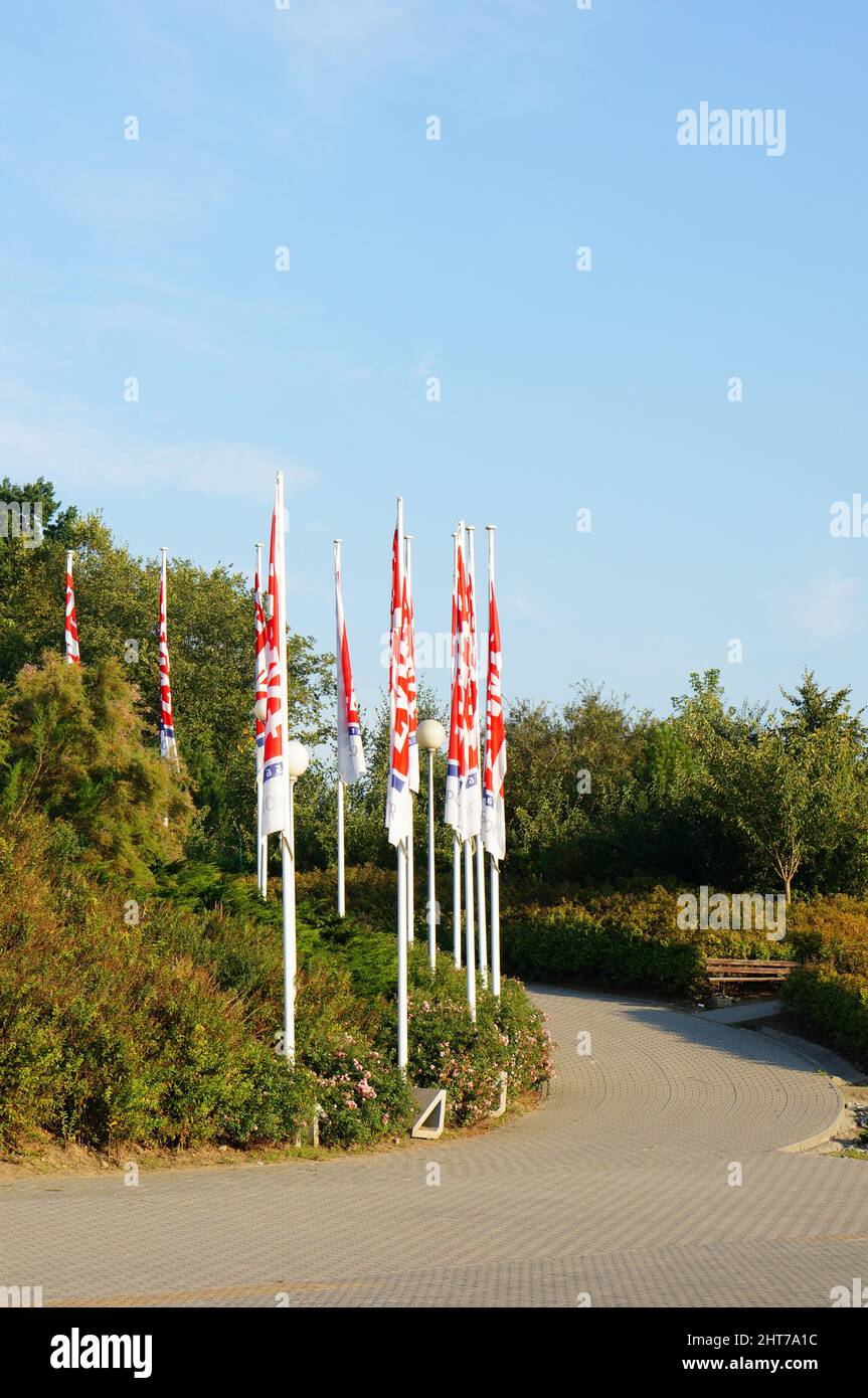 Vertical shot of a group of high flags with the Zywiec logo at the ...