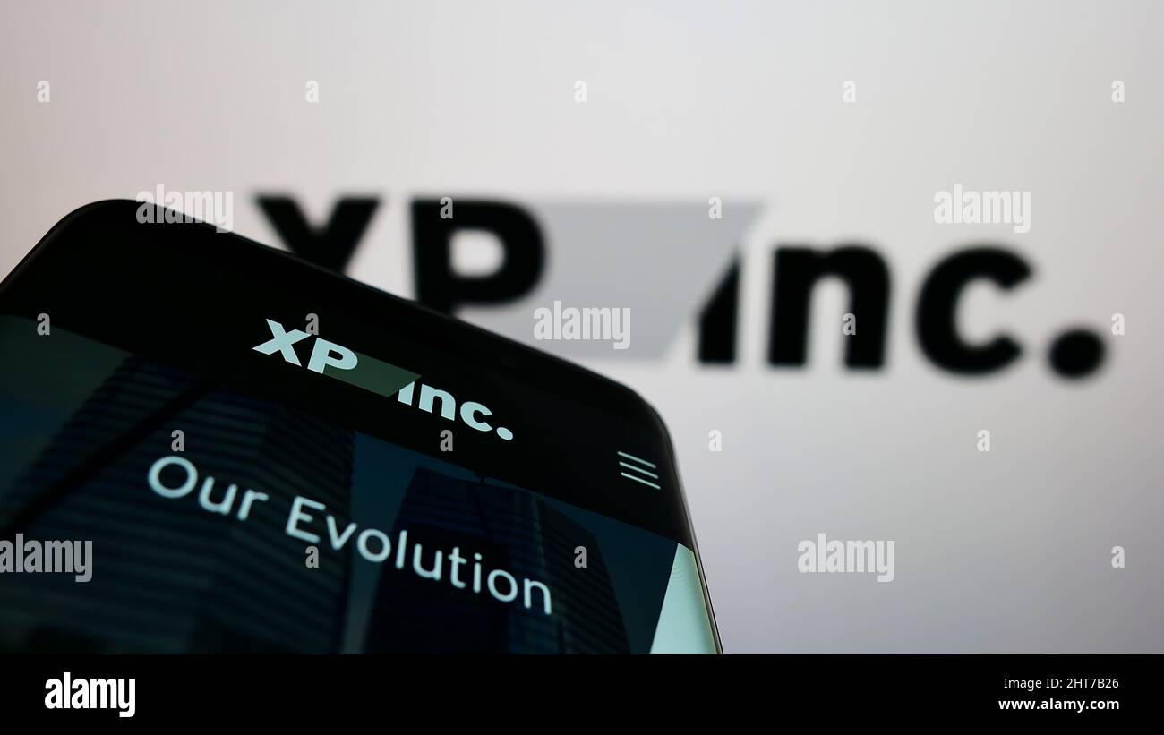 Mobile phone with webpage of Brazilian investment company XP Inc. on ...