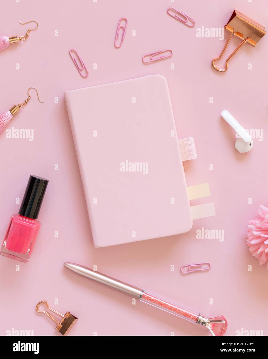 Hardcover notebook and Pink school accessories on pastel pink, top view ...