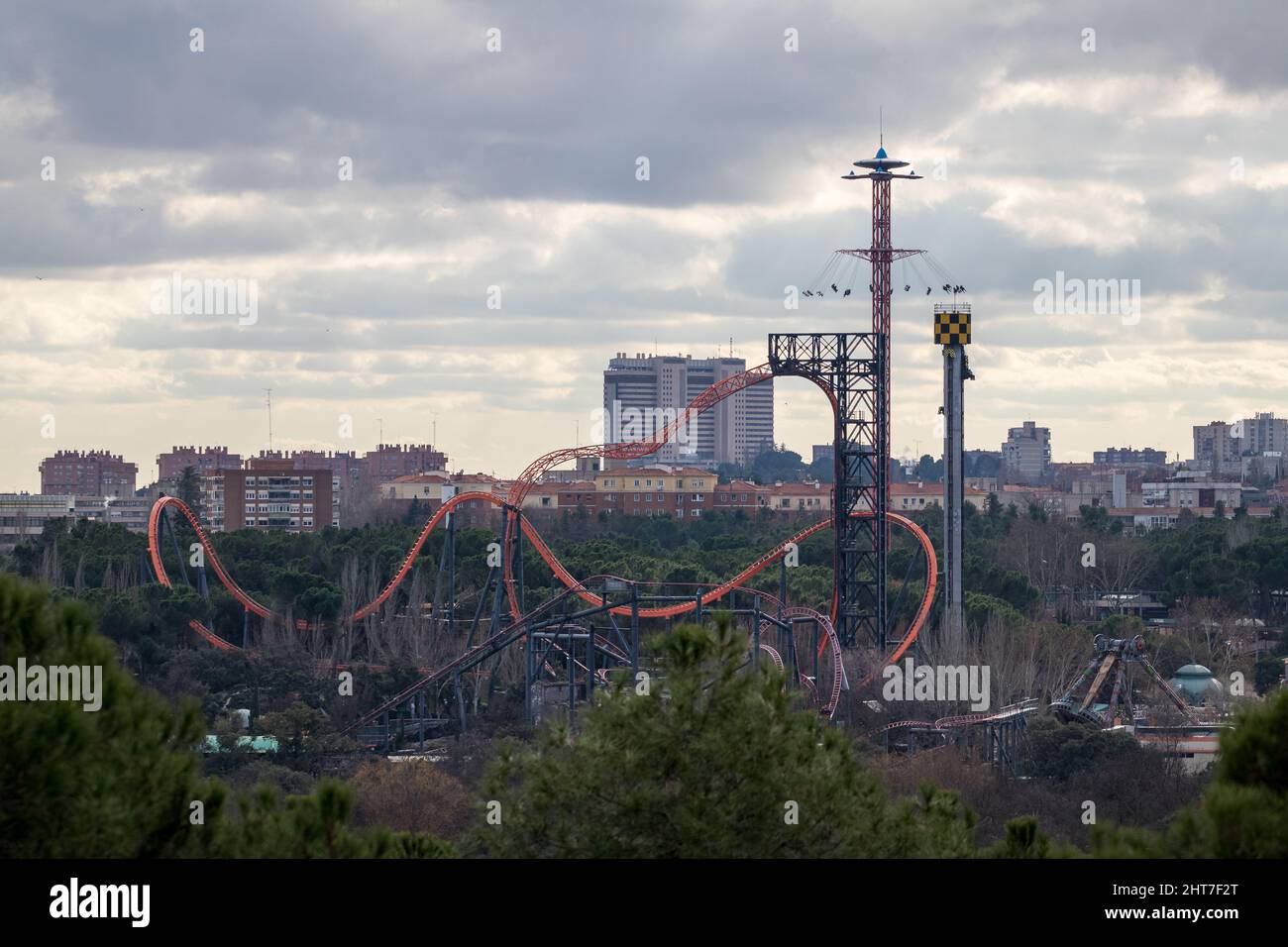 Aerial view of an adventure park with carousels under the cloudy sky ...