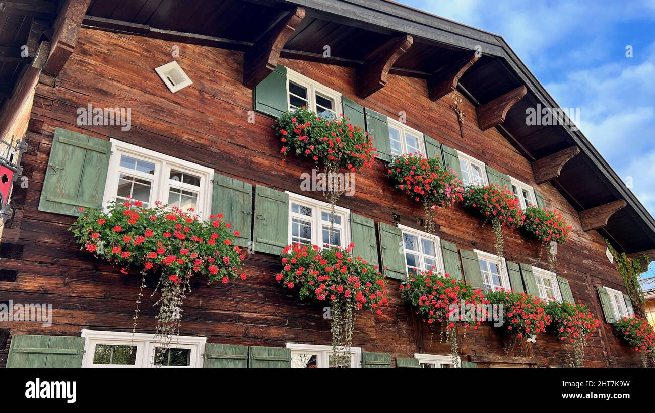 Closeup of a small wooden building with white windows and decorative ...