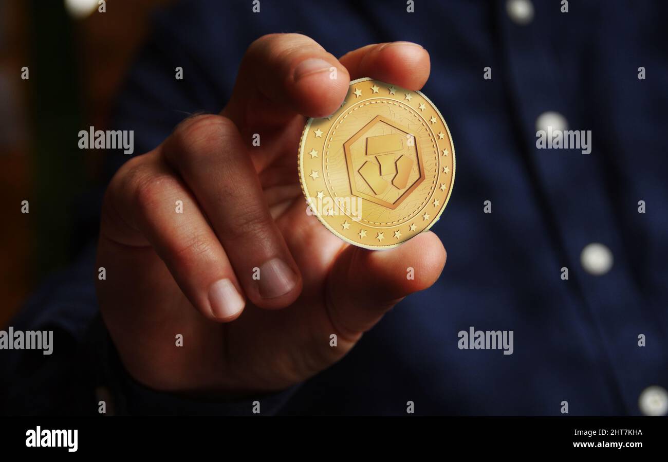 Crypto.com CRO cryptocurrency symbol golden coin in hand abstract ...