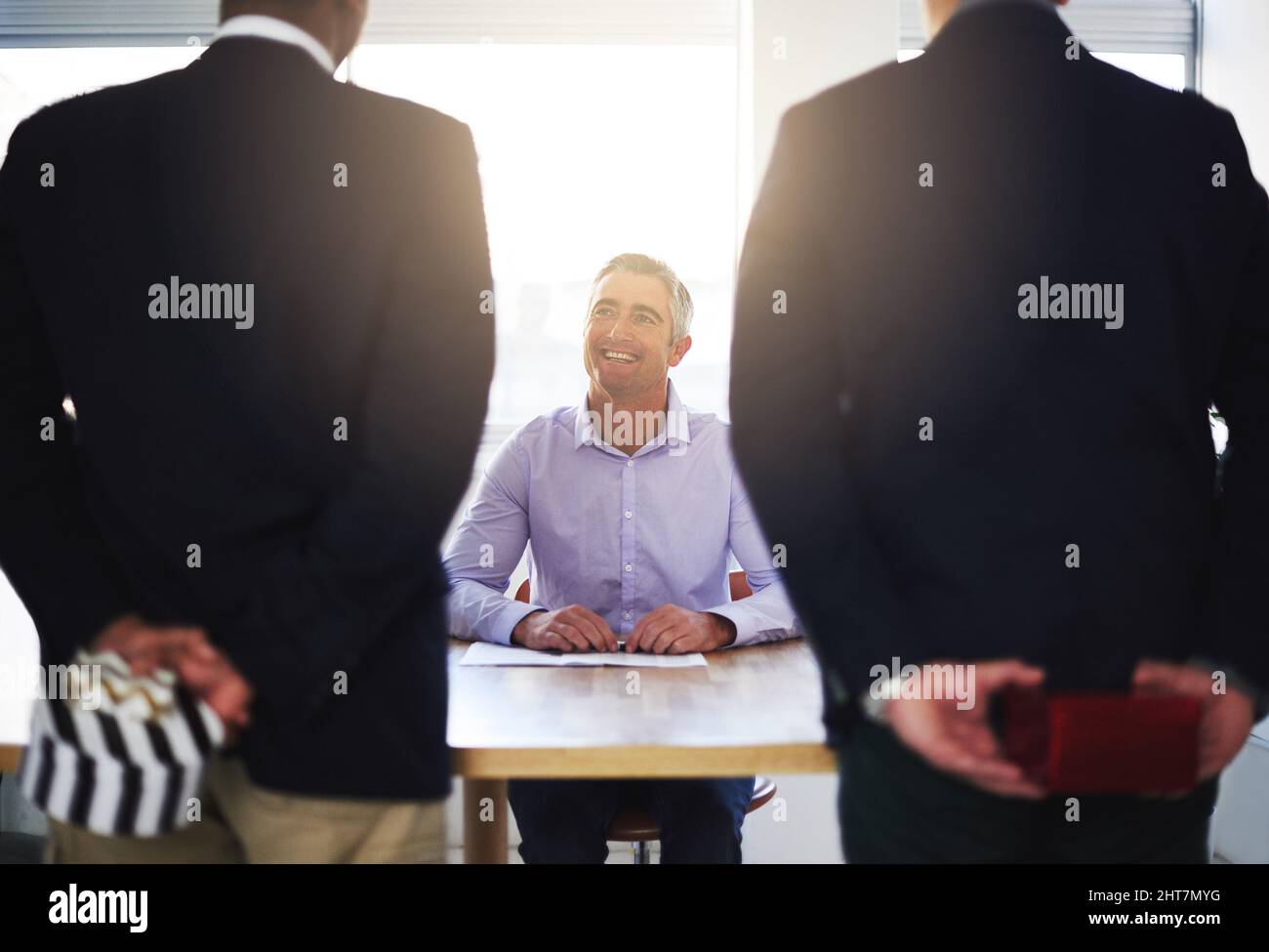 Boss sitting behind desk standing hi-res stock photography and images ...