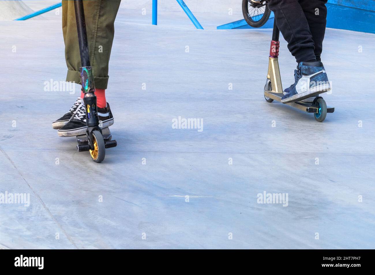 Skater boys having fun practicing at the outdoors skate park on a ...