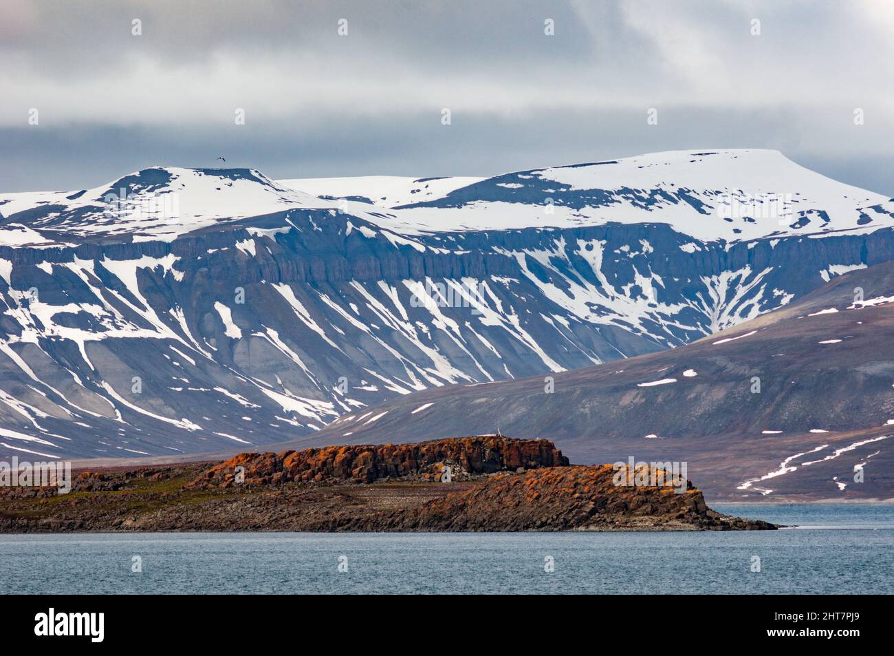 Winter scene with snow-covered mountains over the sea, Spitsbergen ...