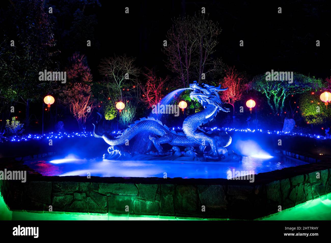 Chinese dragon statue lit by neon lights at park Stock Photo - Alamy
