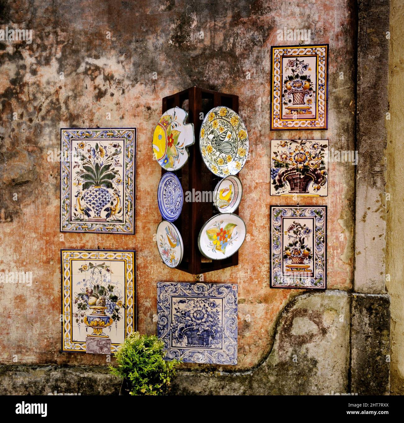 A selection of handmade and decorated plates on a market stall in ...