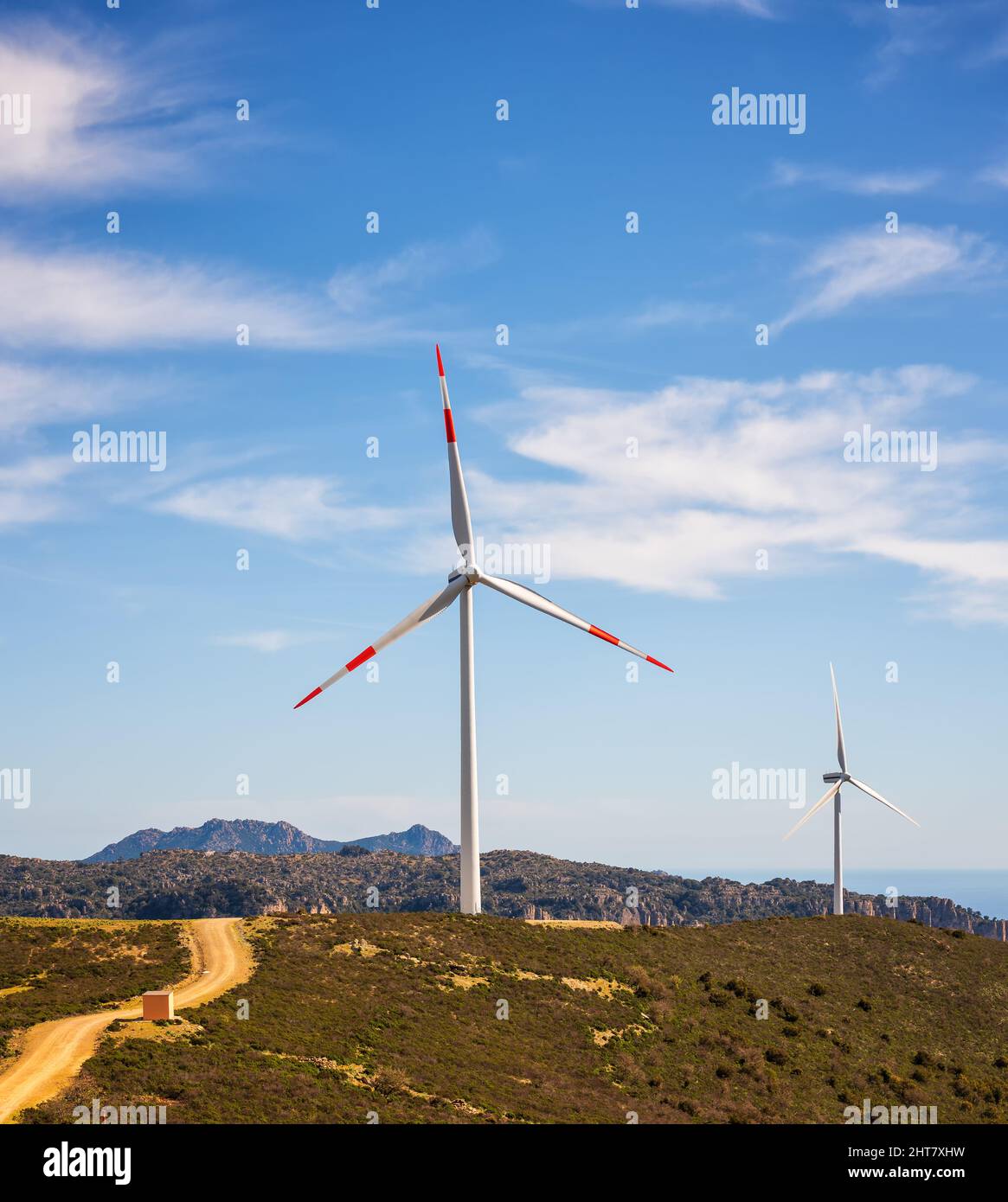 Wind turbines on a beautiful blue sky with clouds in a mountain wind ...