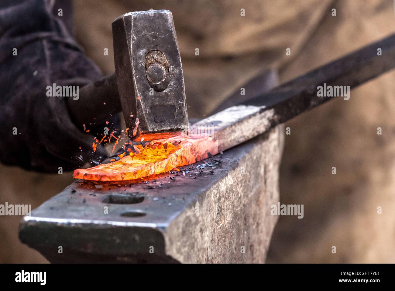 A Sword smith shaping a blade on an anvil Stock Photo - Alamy