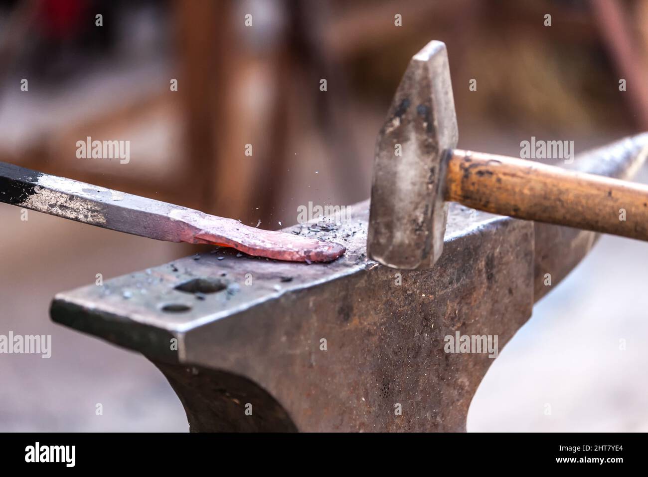 A Sword smith shaping a blade on an anvil Stock Photo - Alamy
