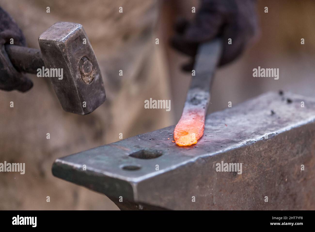A Sword smith shaping a blade on an anvil Stock Photo - Alamy