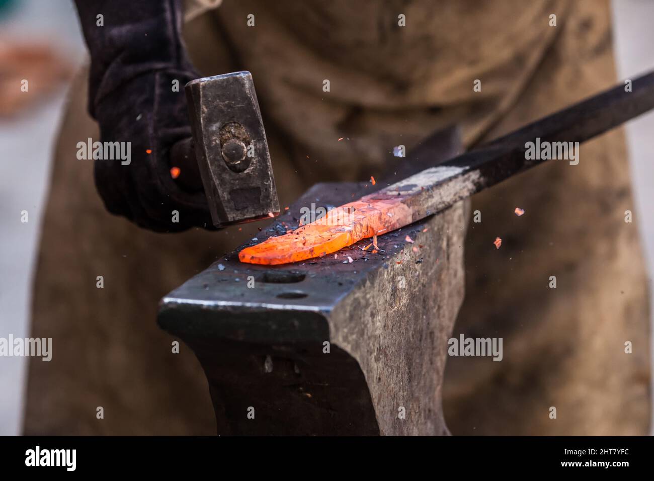 A Sword smith shaping a blade on an anvil Stock Photo - Alamy