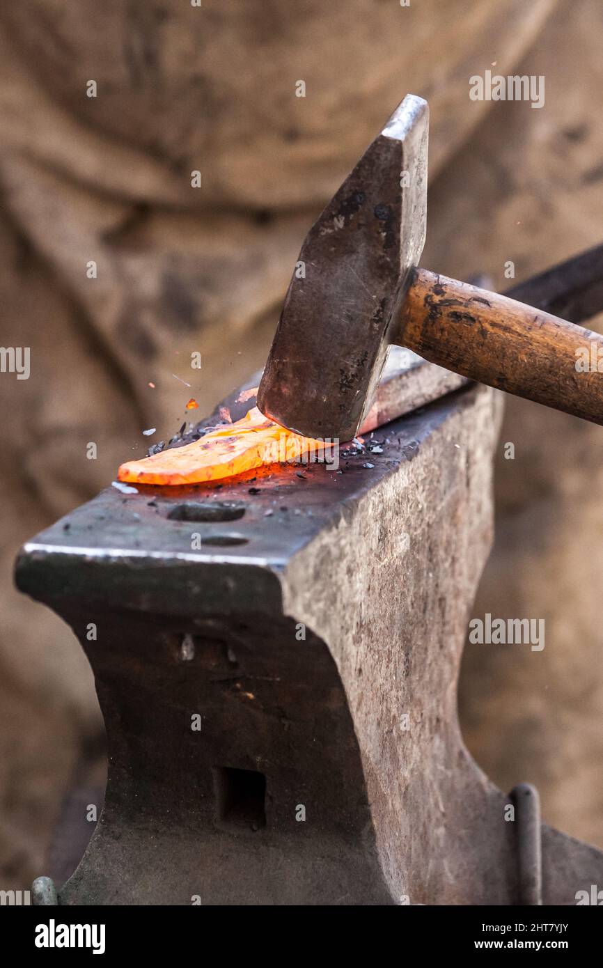 A Sword smith shaping a blade on an anvil Stock Photo - Alamy