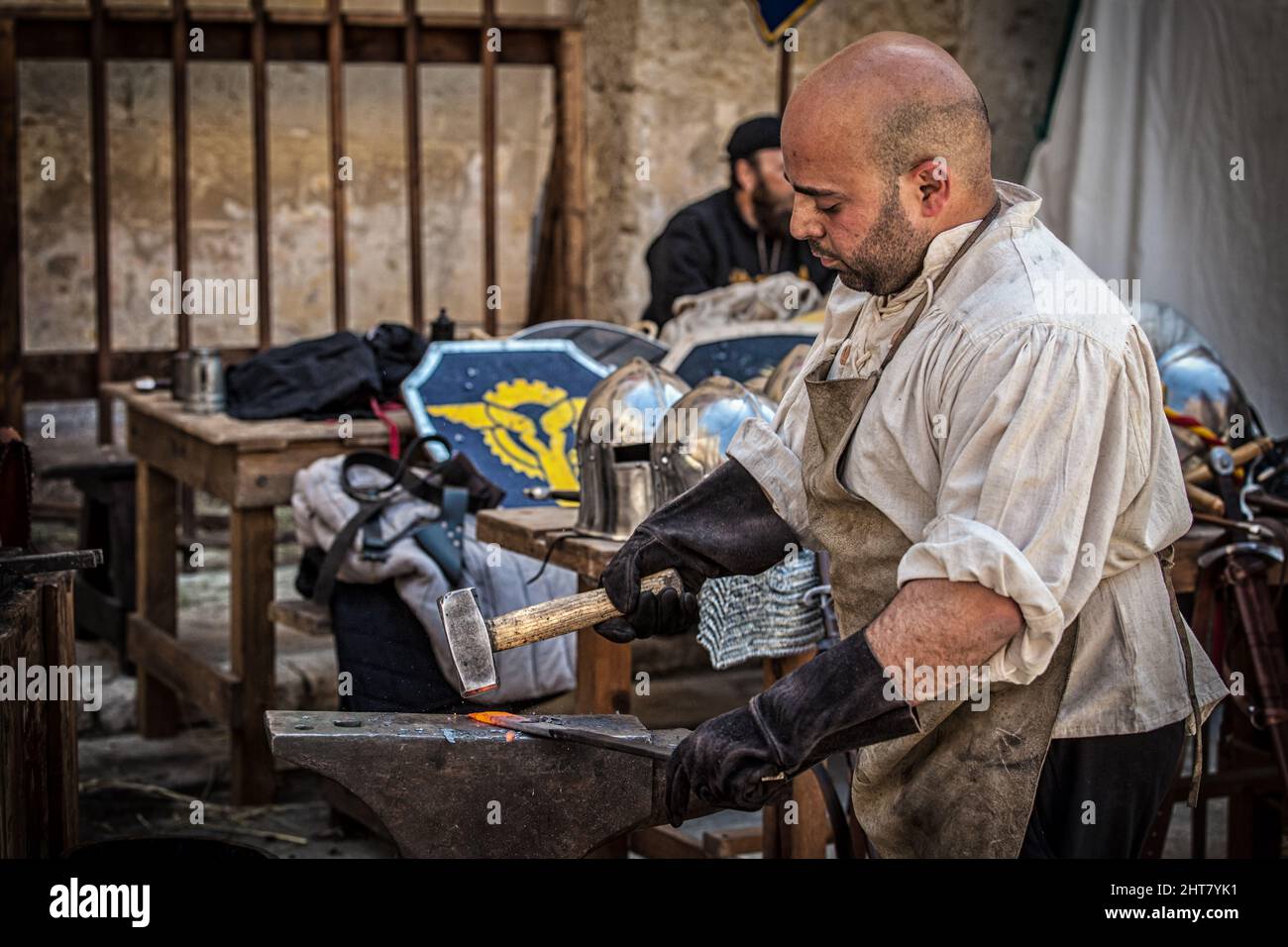 A Sword smith shaping a blade on an anvil Stock Photo - Alamy