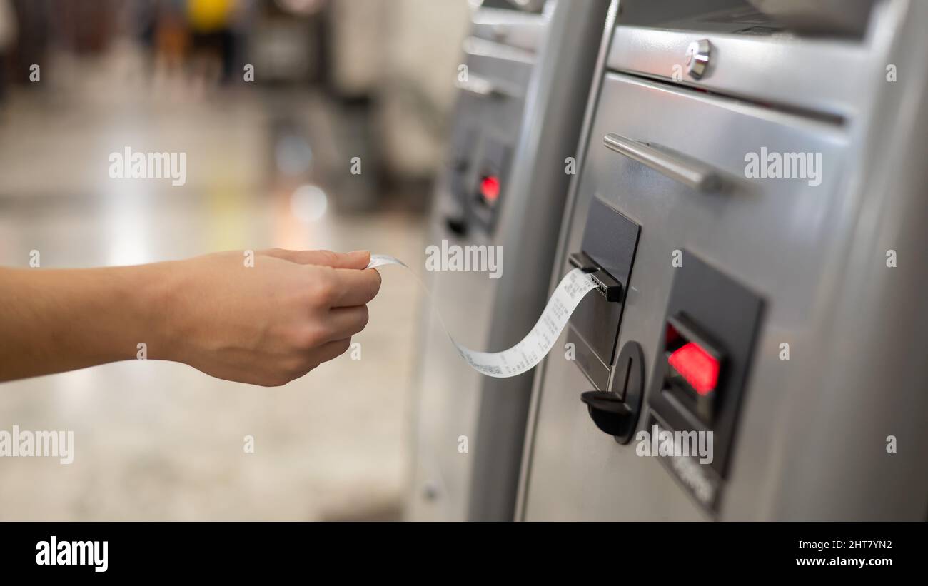 A woman takes a printed check from an ATM Stock Photo - Alamy