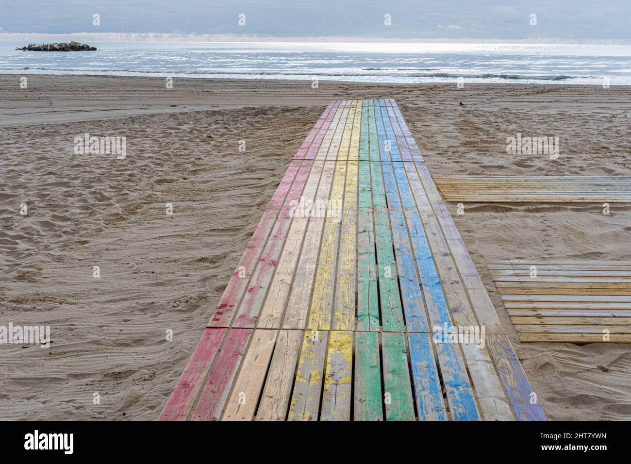 Wooden walkways on the beach, painted in rainbow colors Stock Photo - Alamy