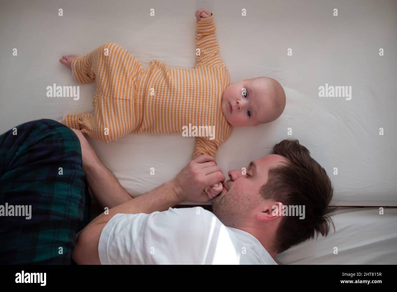 Sleeping father and cute child resting together in bed Stock Photo - Alamy