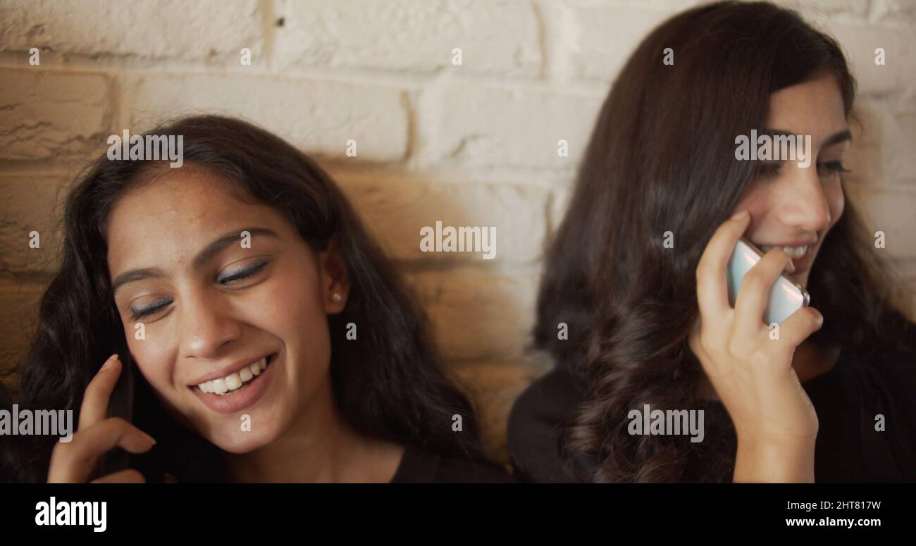 Two Indian females calling on their smartphones Stock Photo - Alamy