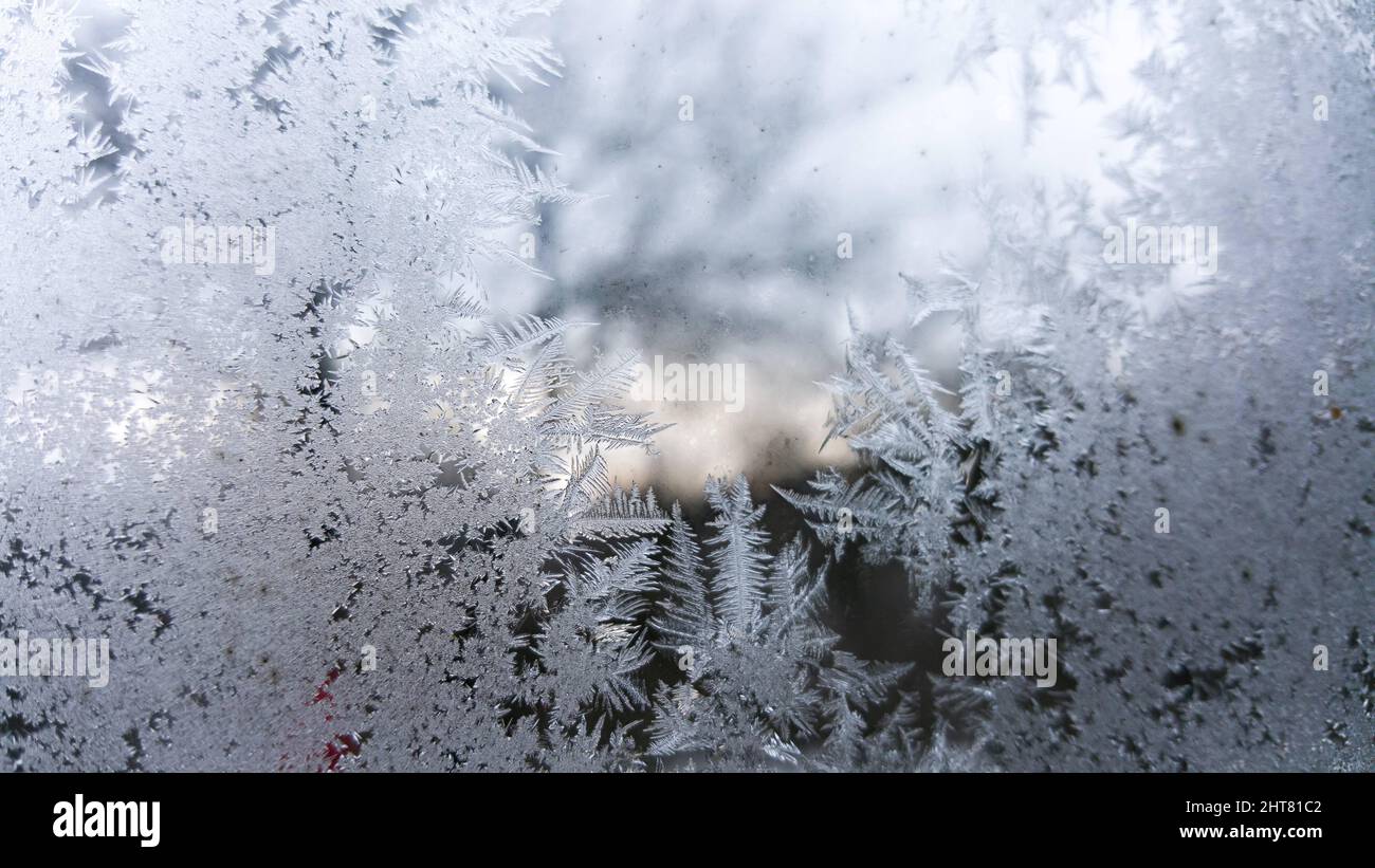 Horizontal background of a frozen window with beautiful snowflake ...