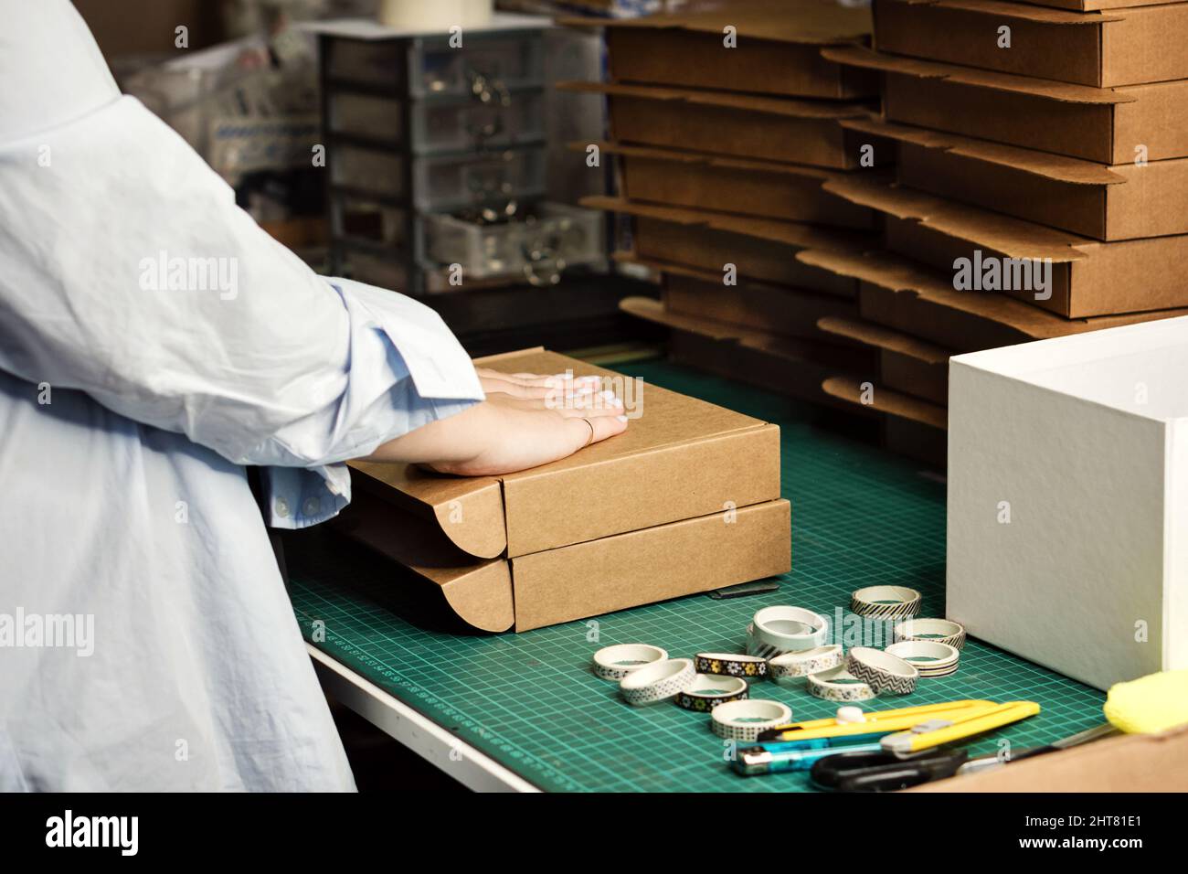 Packing goods in cardboard boxes in the warehouse before delivery ...