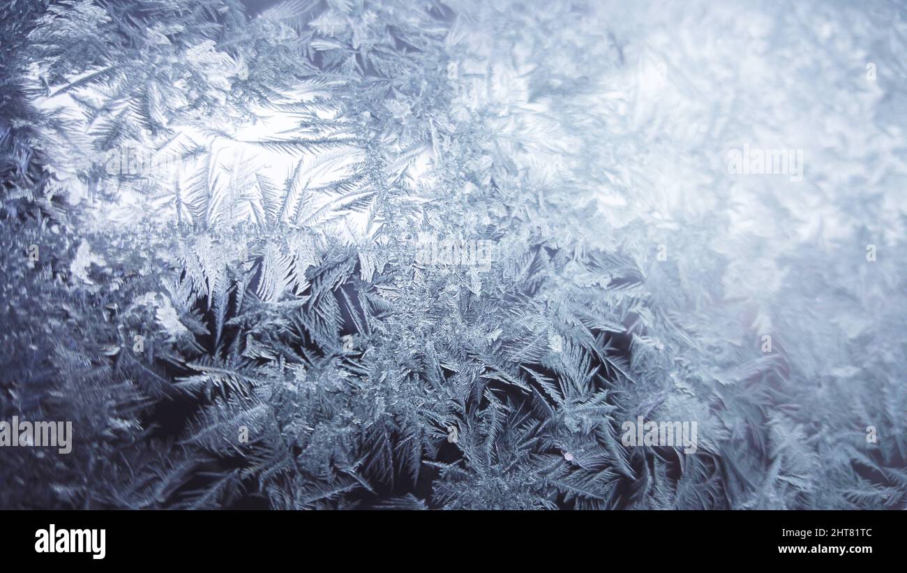 Horizontal background of a frozen window with beautiful snowflake ...