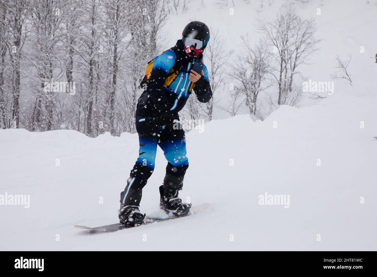 Snowboarder riding fast on snow freeride slope Stock Photo - Alamy