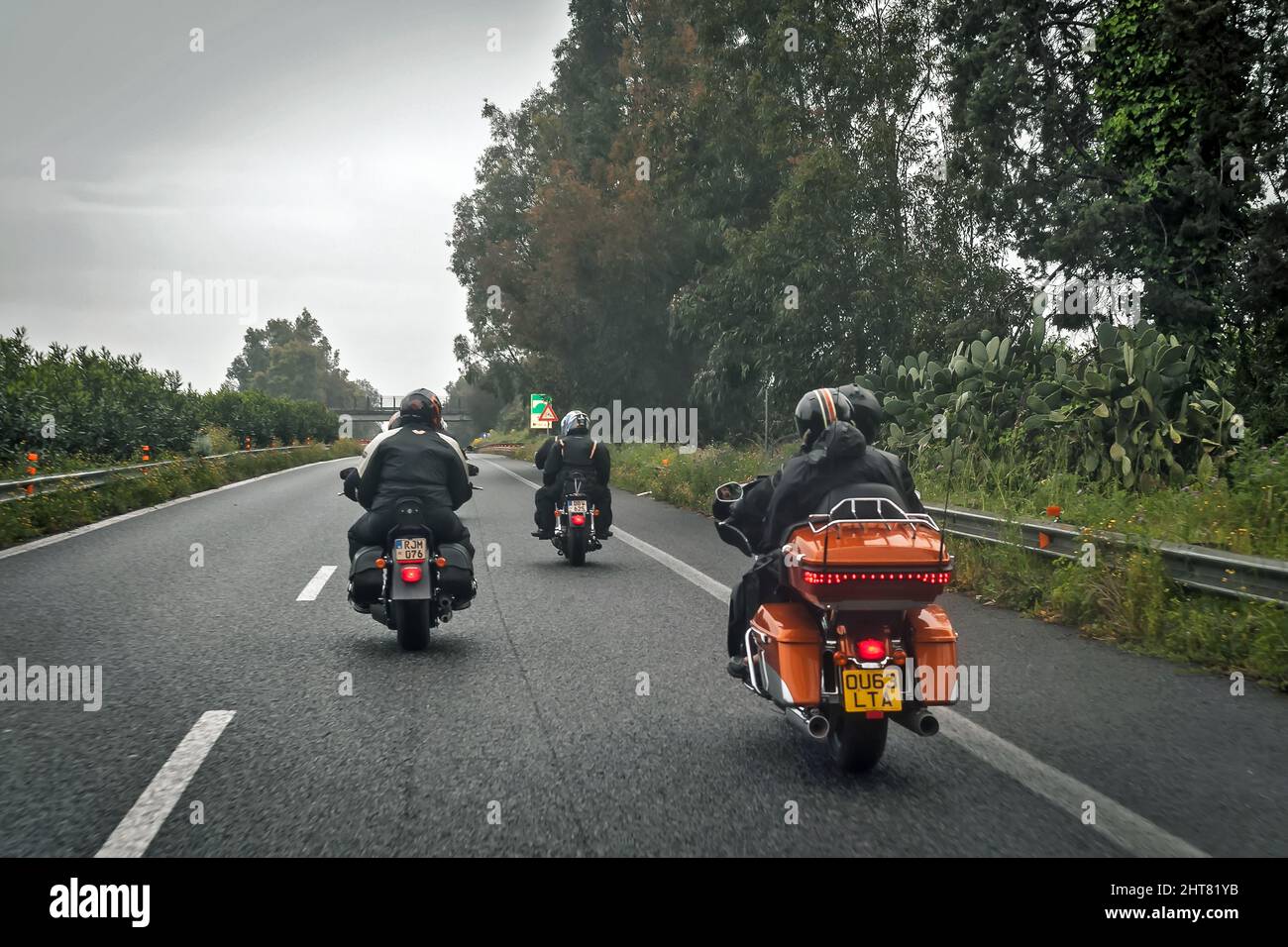 Motorcycle Riders ride down the road Stock Photo - Alamy