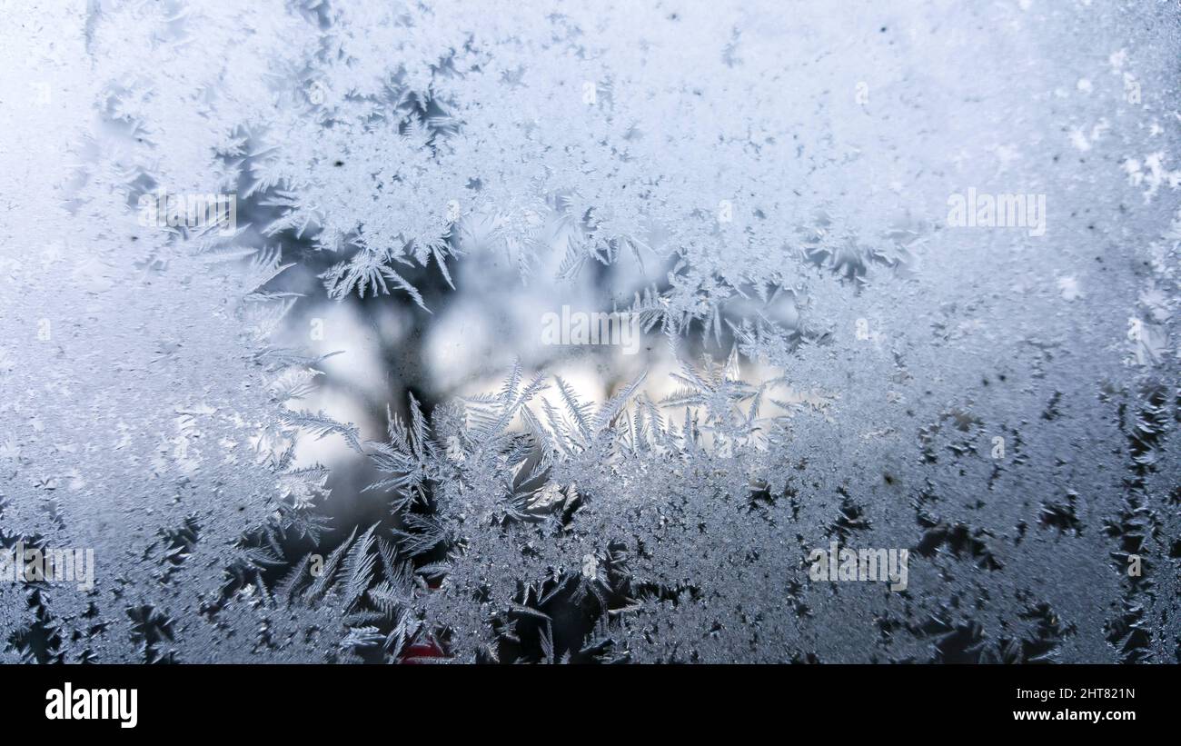 Horizontal background of a frozen window with beautiful snowflake ...