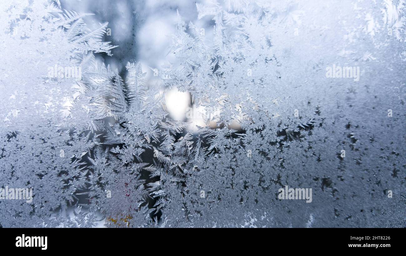 Horizontal background of a frozen window with beautiful snowflake ...