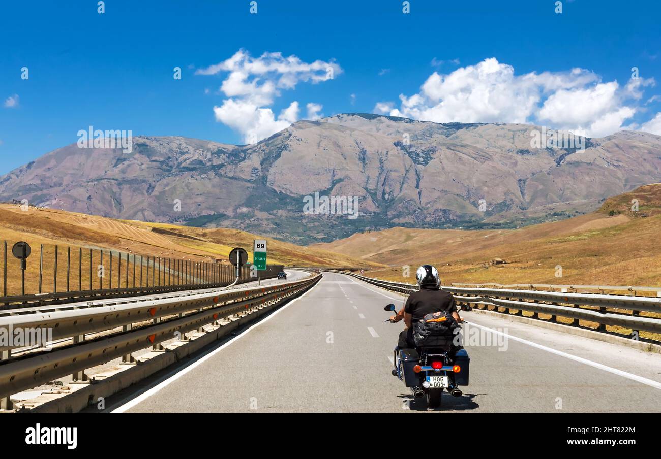 Motorcycle Riders ride down the road Stock Photo - Alamy