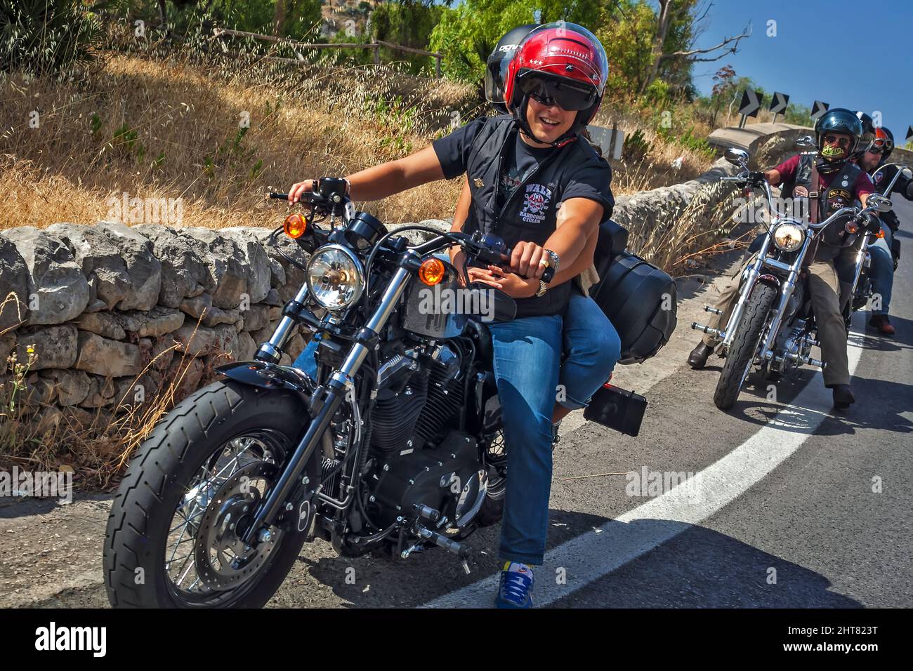 Motorcycle Riders ride down the road Stock Photo - Alamy