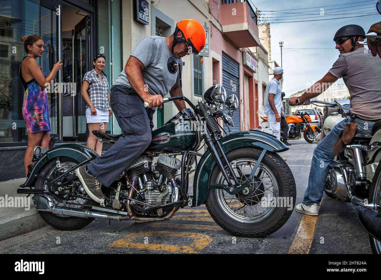 A Motorcycle Rider Kick Starts His Classic Bike Stock Photo - Alamy