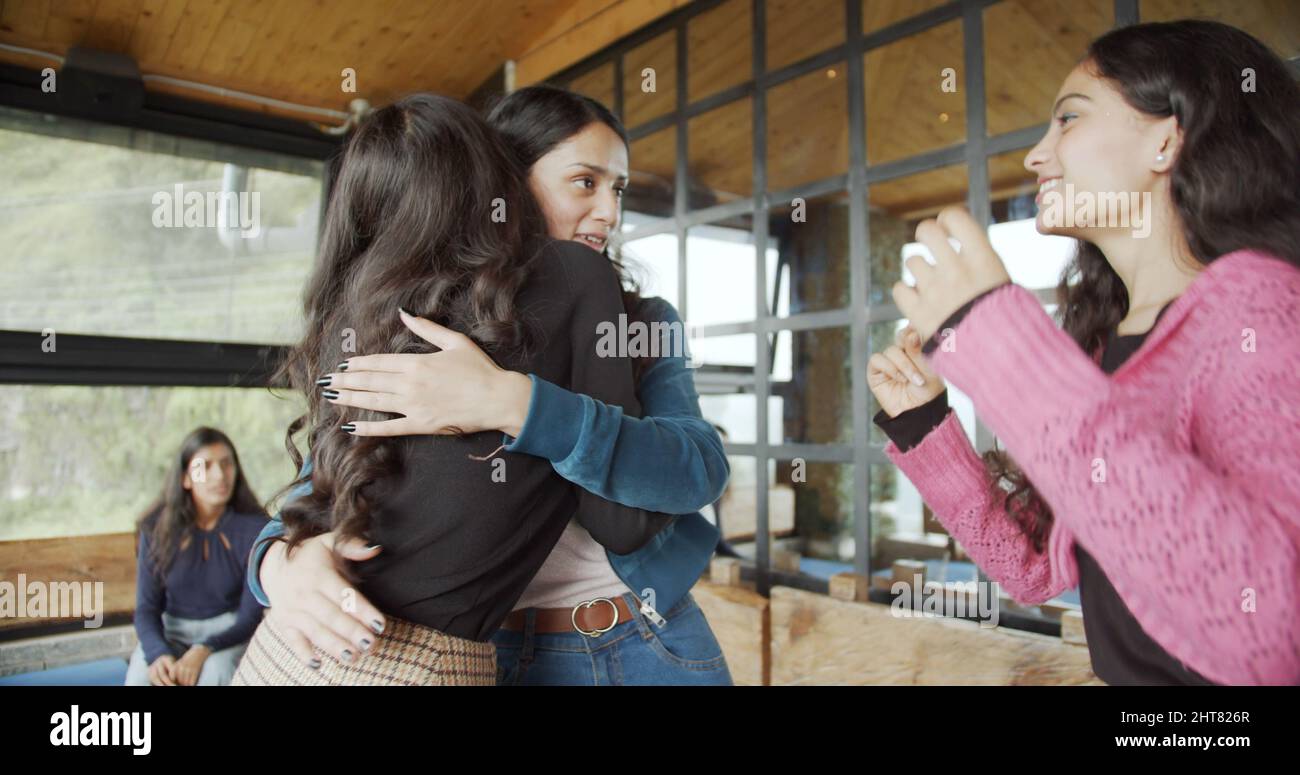 Affectionate young South Asian ladies at a cafe Stock Photo - Alamy