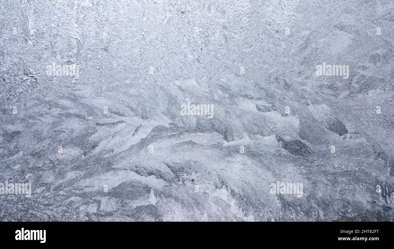 Horizontal background of a frozen window with beautiful snowflake ...