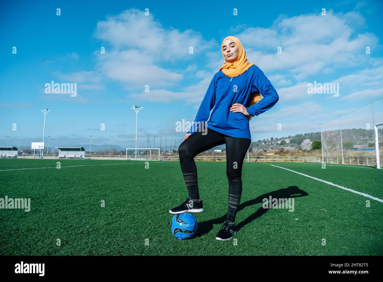 Arab female football player with ball on field Stock Photo - Alamy