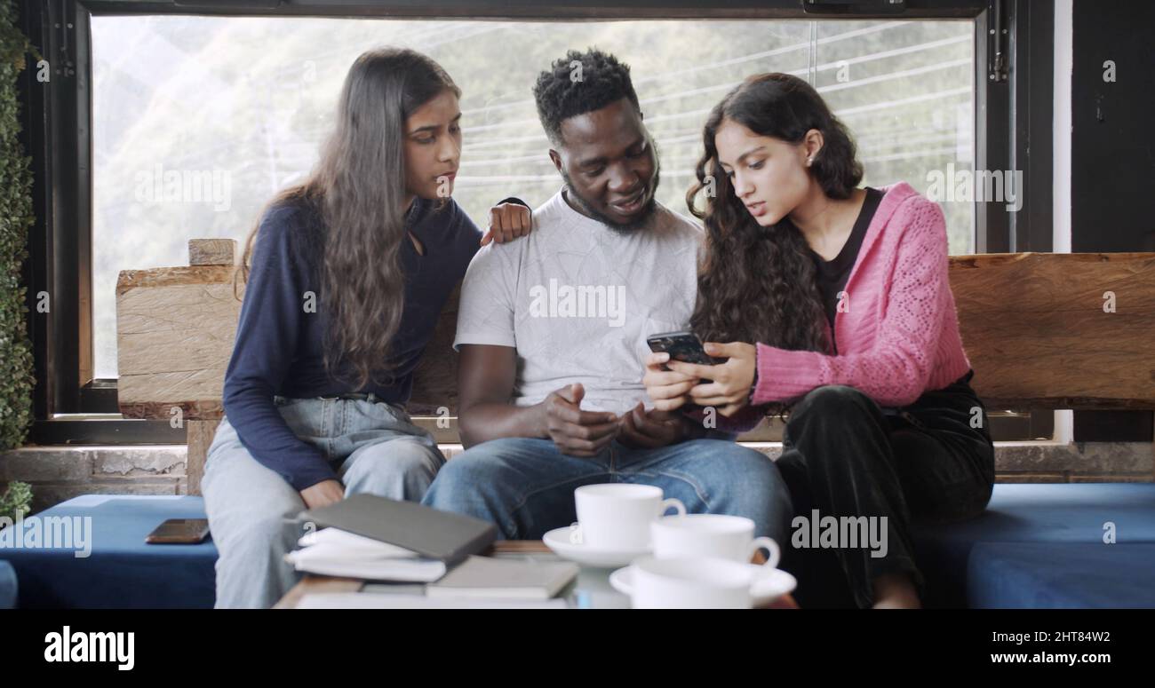Indian female showing her friends something from her smartphone Stock ... Indian female showing her friends something from her smartphone Stock ...