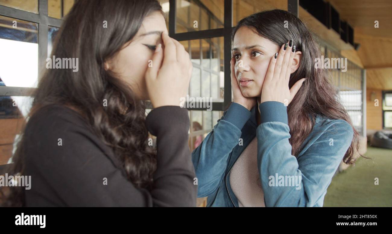 Couple of Indian females talking with each other with serious faces ...