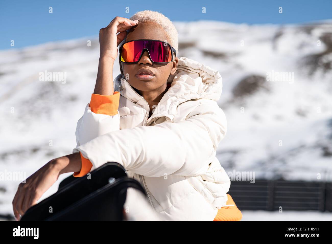 African American woman wearing a winter jacket and glasses in the ... African American woman wearing a winter jacket and glasses in the ...