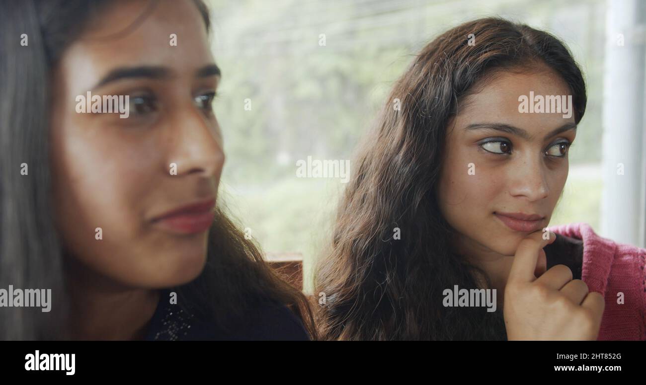 A couple of Indian young females seriously looking at something Stock ...