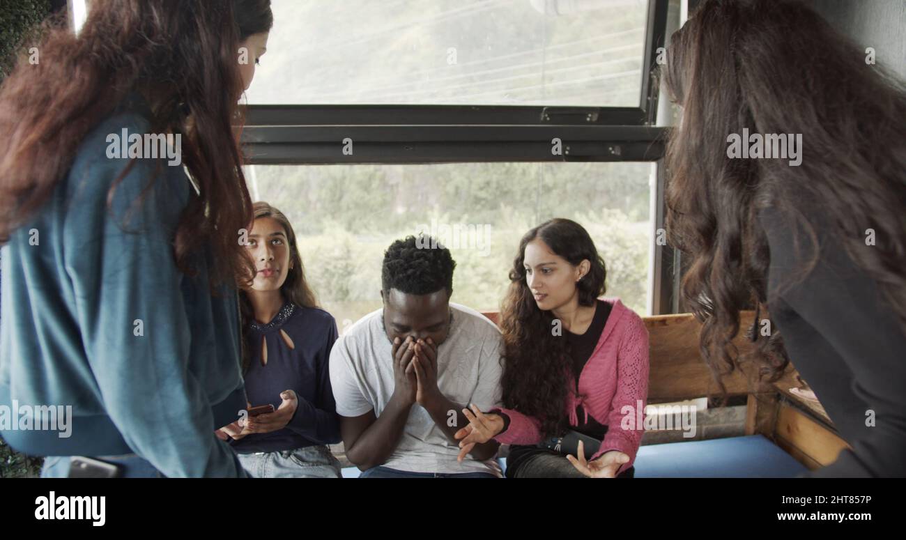 Group of Indian young people talking with each other with serious faces ...