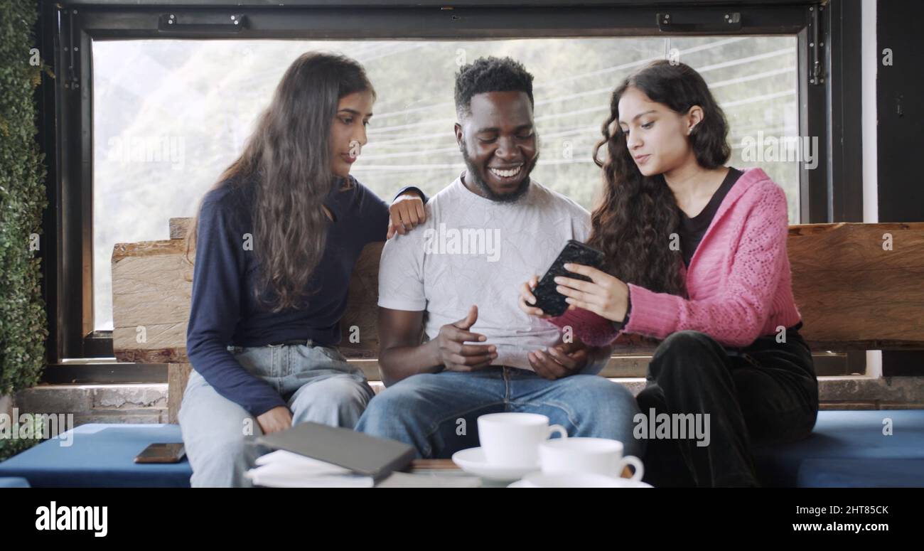 Indian female showing her friends something from her smartphone Stock ... Indian female showing her friends something from her smartphone Stock ...